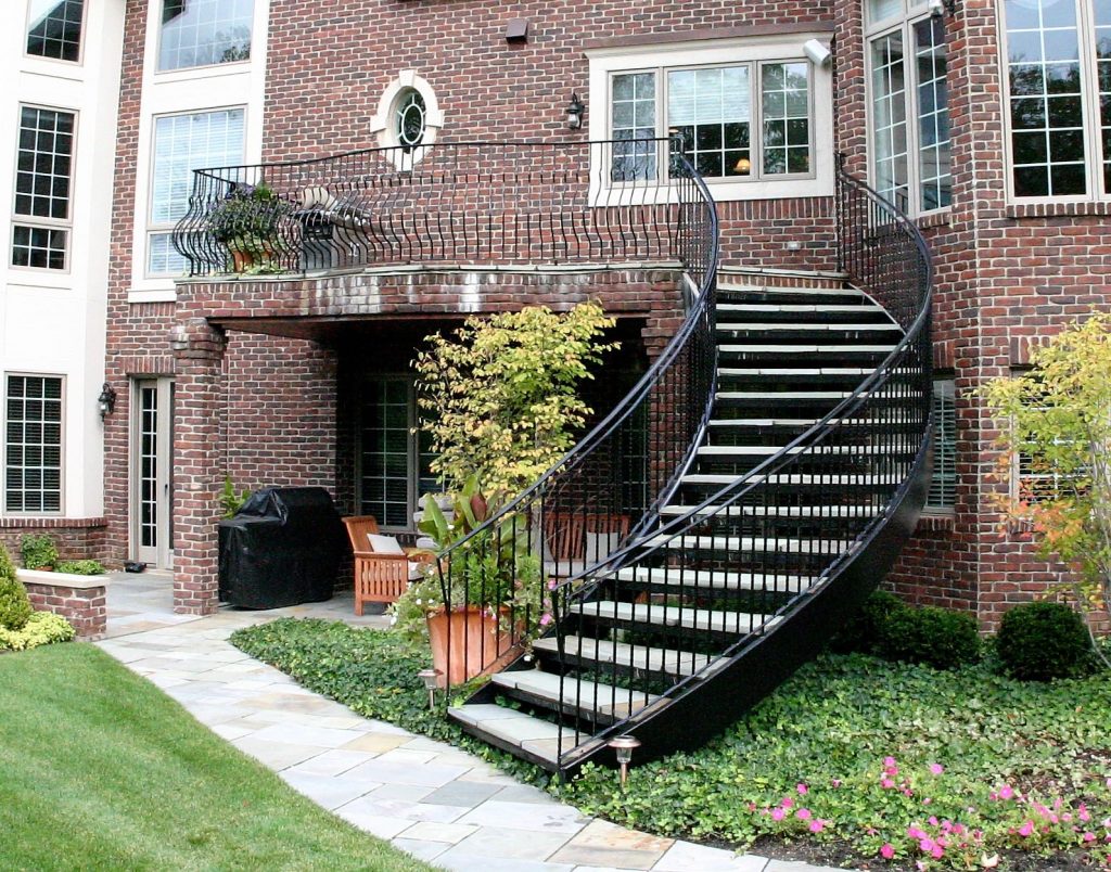 Outdoor Curved Staircase with Wrought Iron Belly Rail