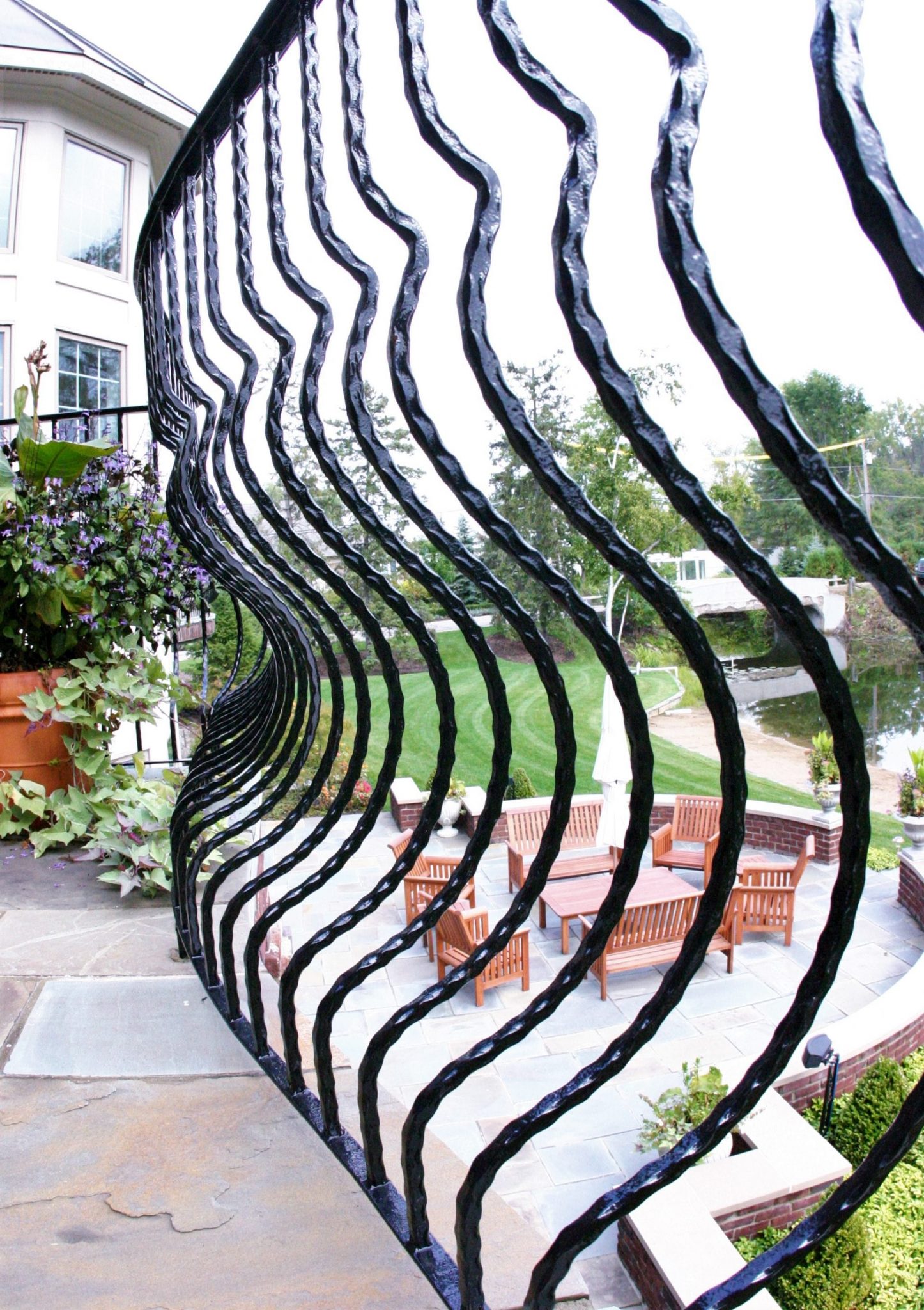 Curved Staircase, Wrought Iron Belly Rail - Great Lakes Metal Fabrication